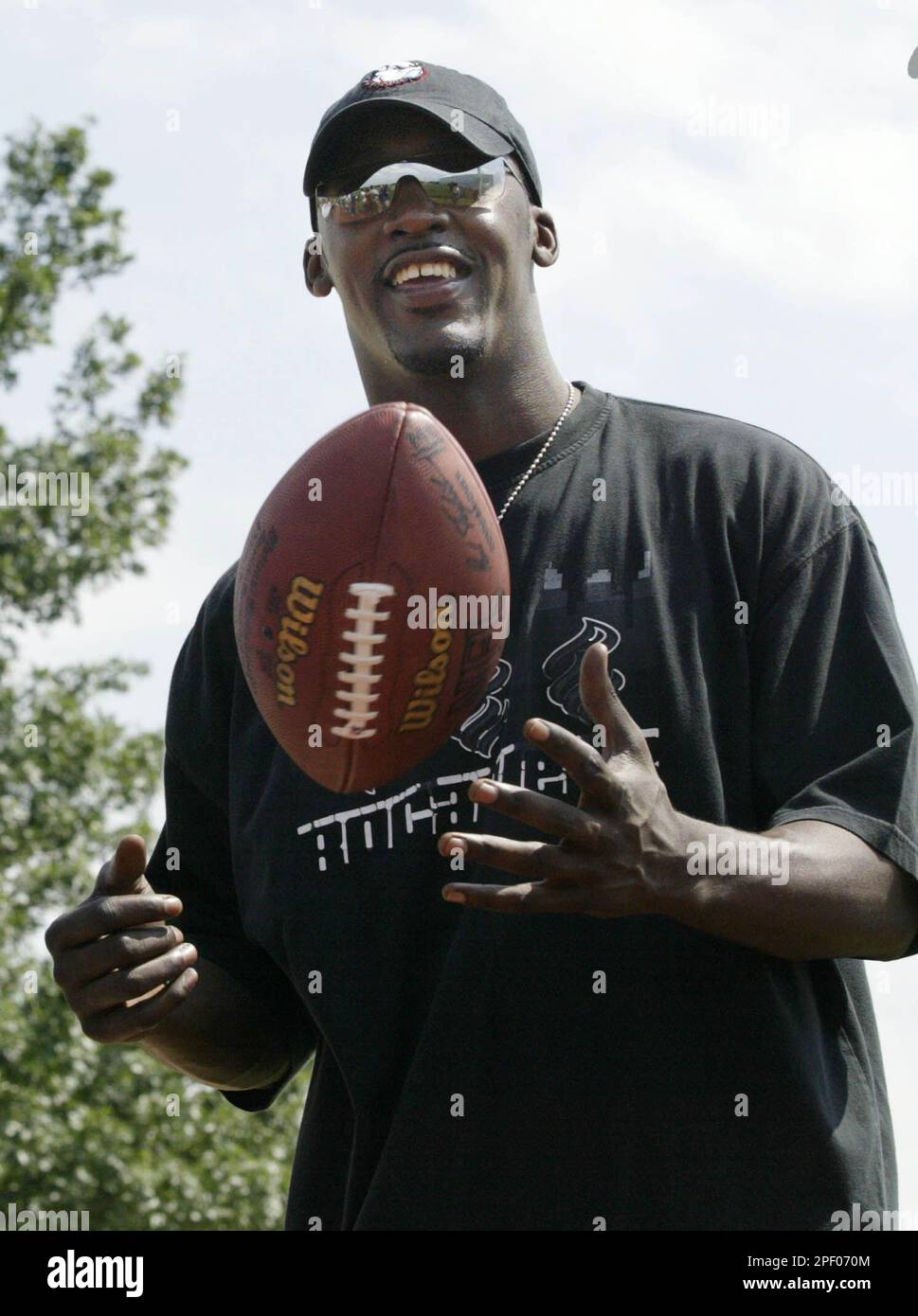 Dallas Cowboys quarterback Quincy Carter tosses a football as he stands ...