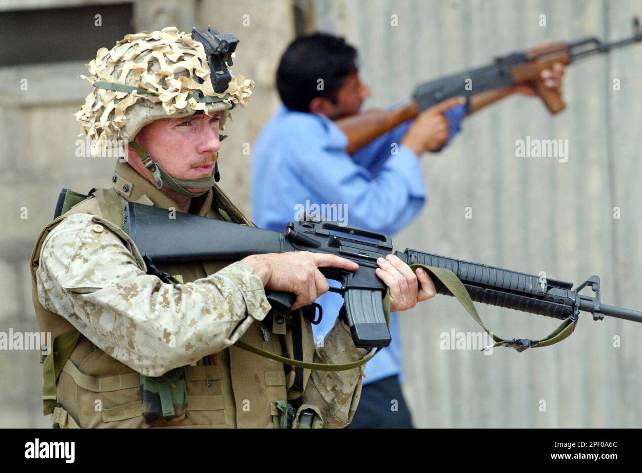 U.S. Marine GySgt. Tracy Reddish from Jesup, GA. patrols with an Iraqi ...