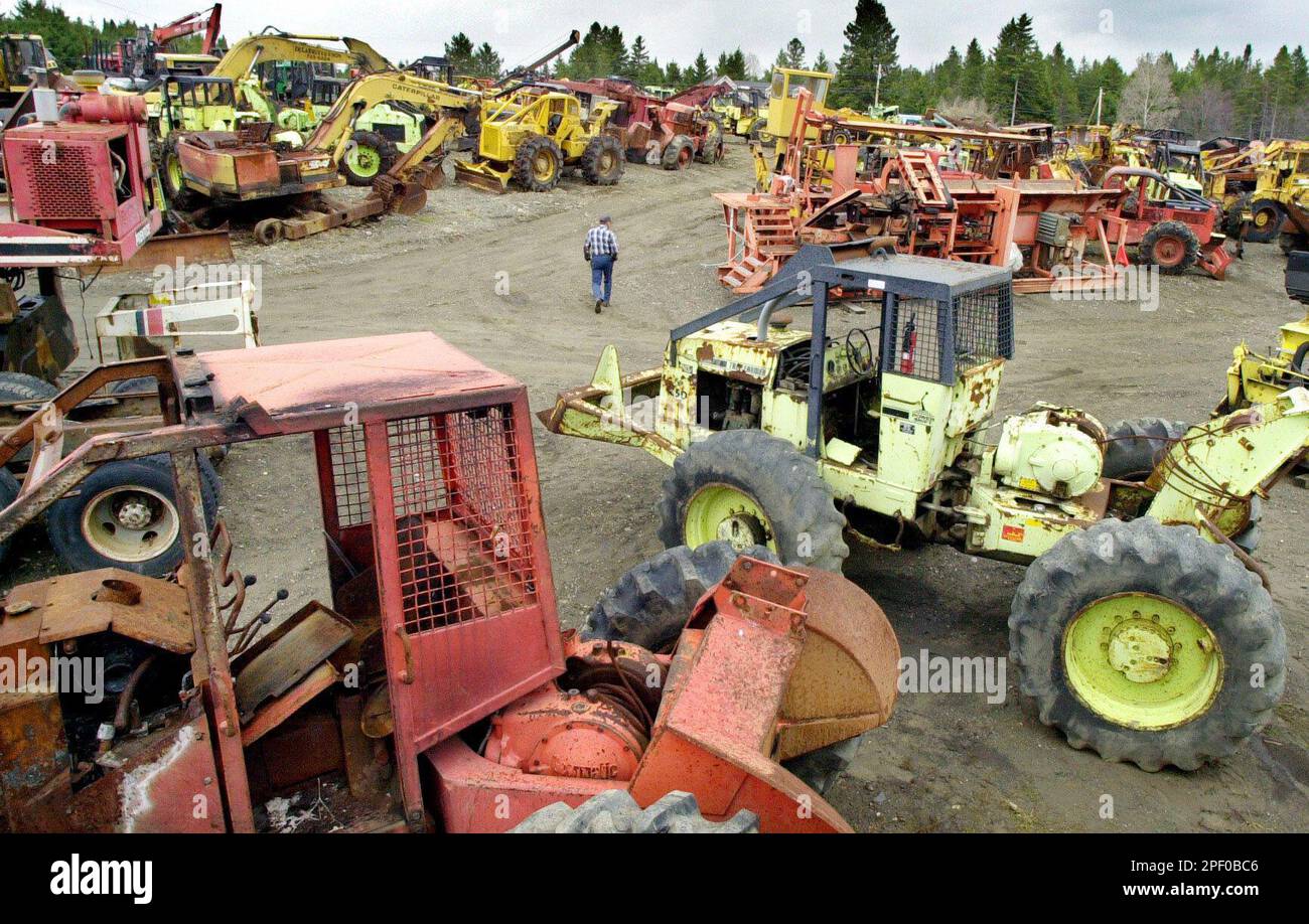 Rusting skidders, foreground, and other heavy logging equipment sit in ...