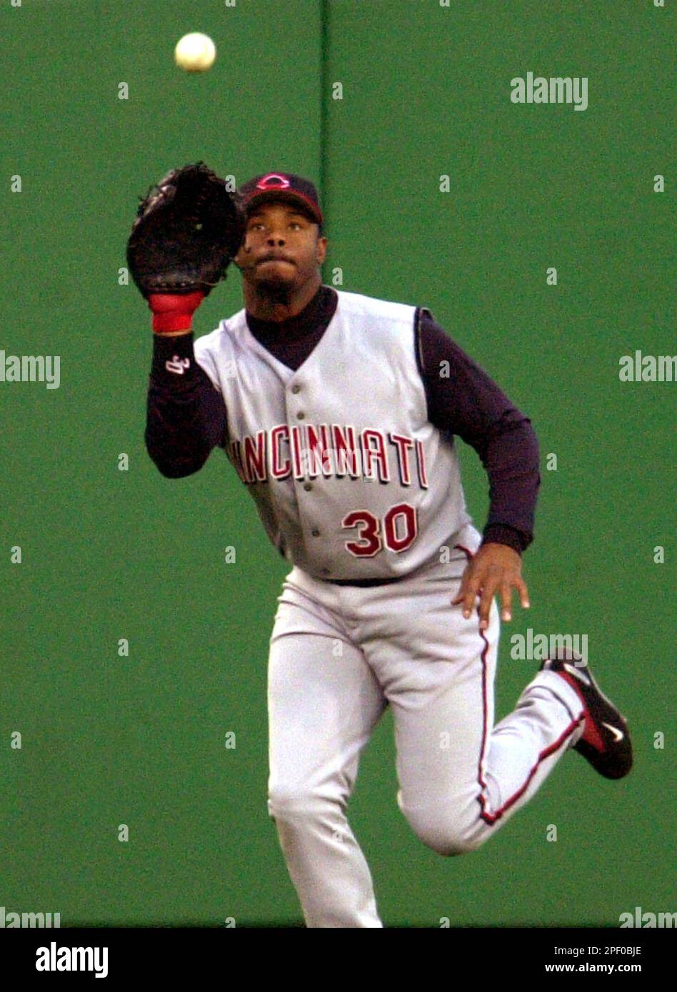 Cincinnati Reds center fielder Ken Griffey Jr. hauls in a first-inning ...