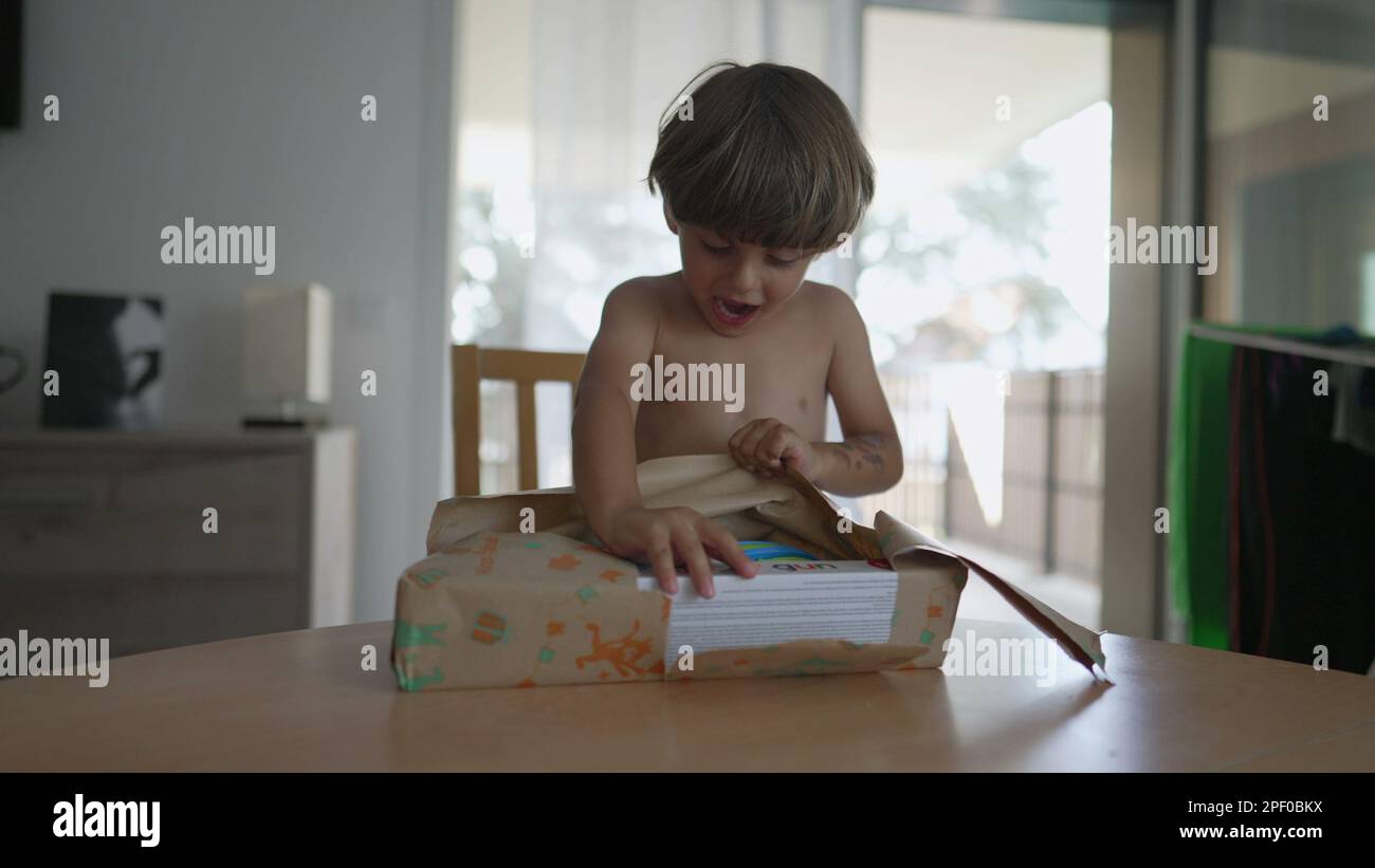 Happy Child opening present. Small boy unwrapping birthday gift Stock ...