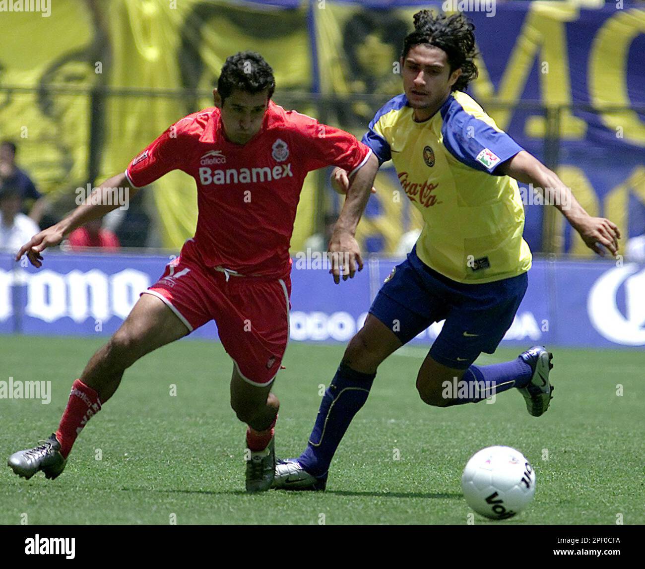 Toluca's Miguel Zepeda, left, fights for the ball with America's Jesus ...