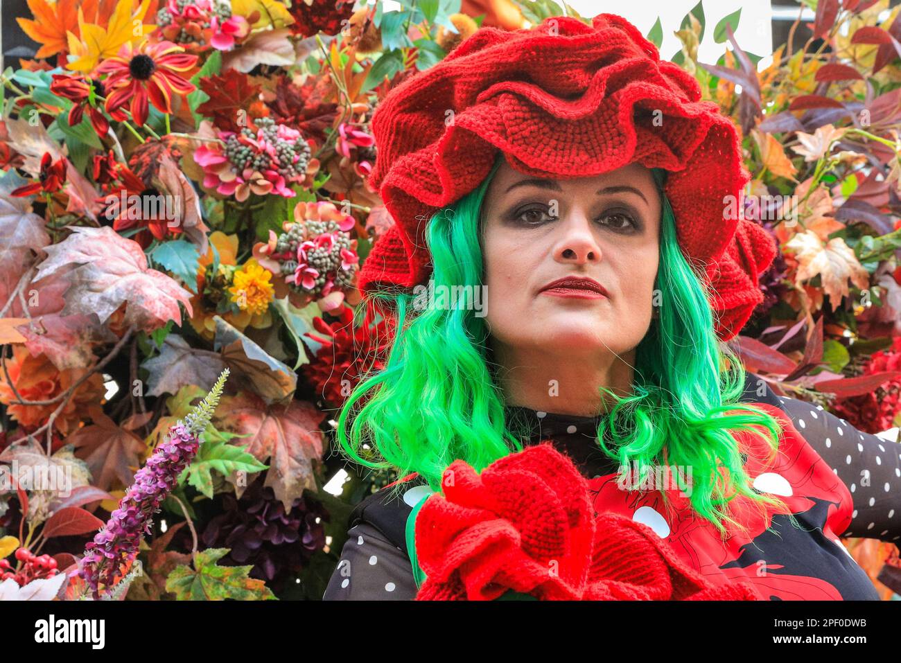 London, UK. 15th Mar, 2023. A participant in hand-crocheted hat poses ...