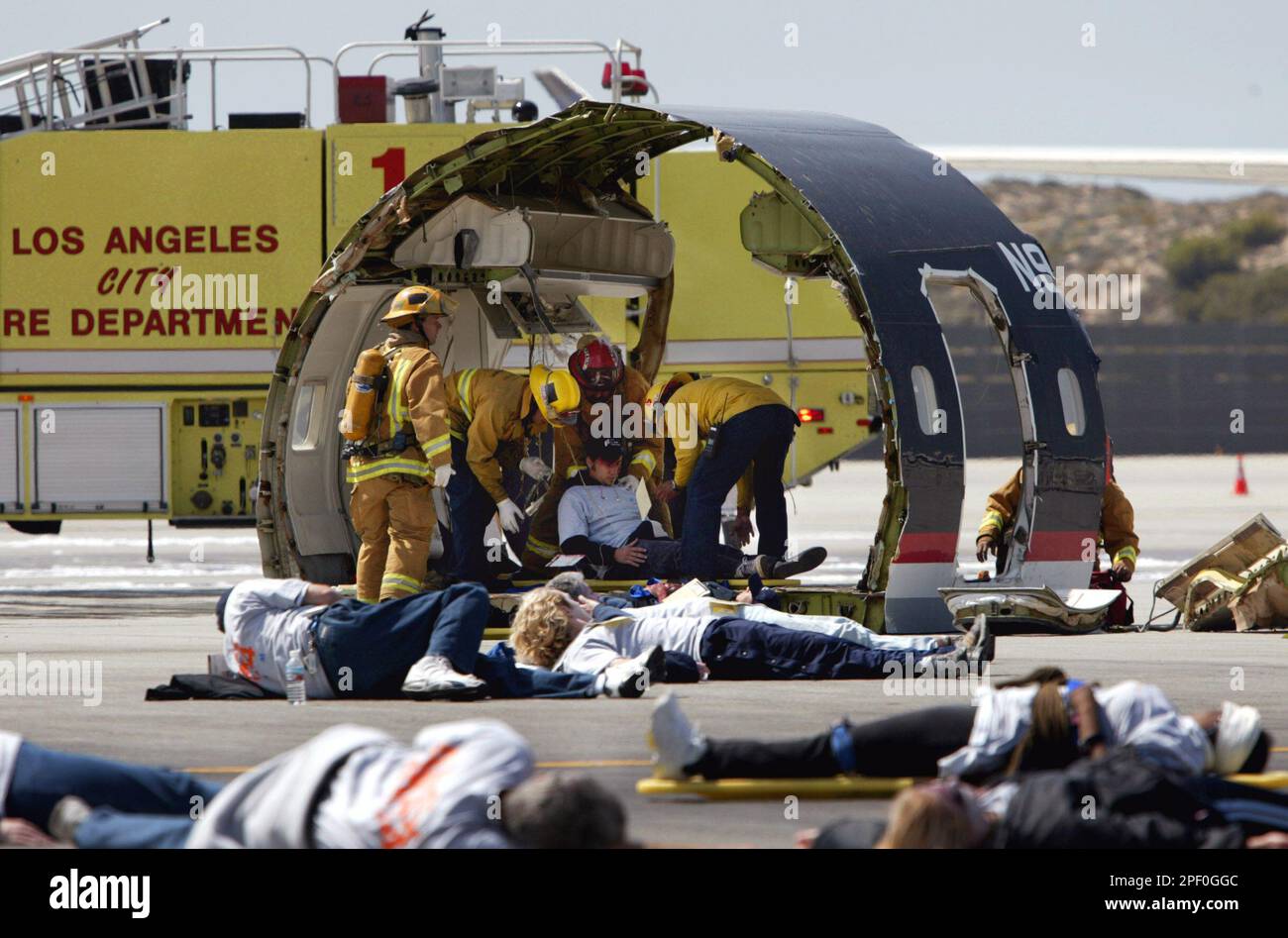 Firefighters remove a victim from the fuselage of cargo aircraft during ...