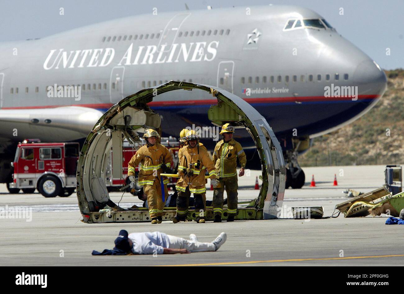 Firefighters remove a victim from the fuselage of cargo aircraft during ...