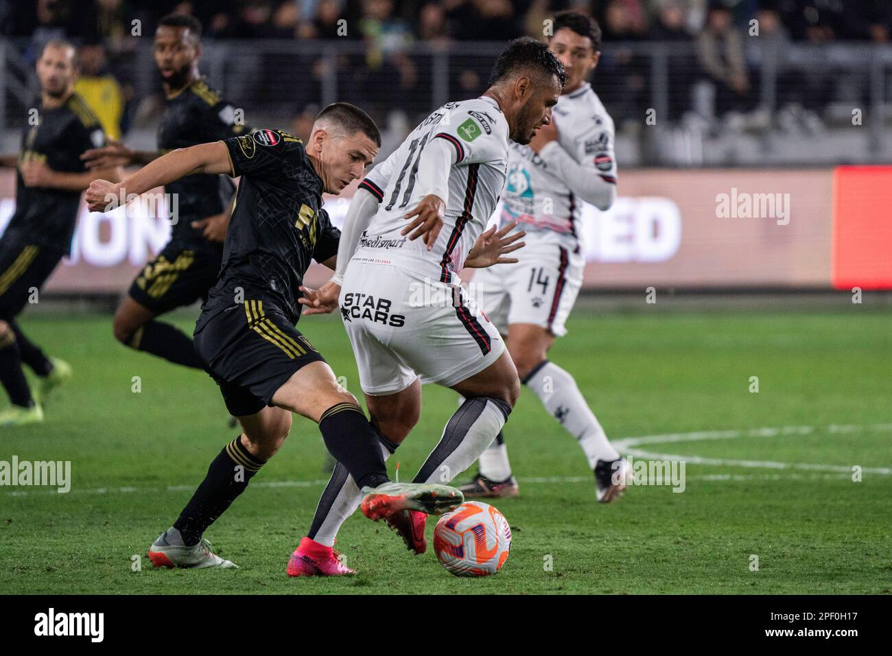 LAFC defender Sergi Palencia (30) and Alajuelense midfielder Alexander Lopez (11) fight for ...