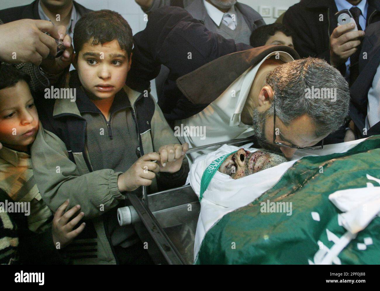 Palestinian relatives of Hamas leader Abdel Aziz Rantisi gather around ...