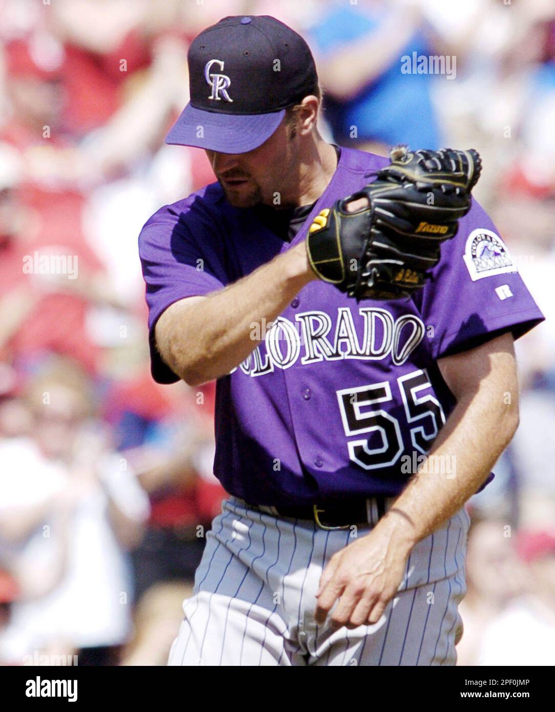 Coloroado Rockies' Shawn Estes slaps his glove after giving up a fifth ...