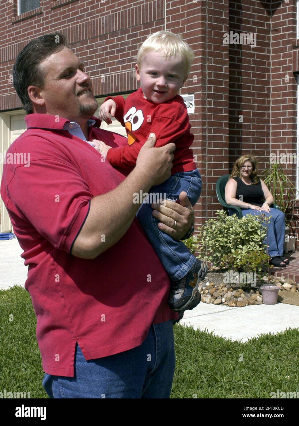 Steve Harryman holds his young son Bryant, 2, outside his Deer Park ...