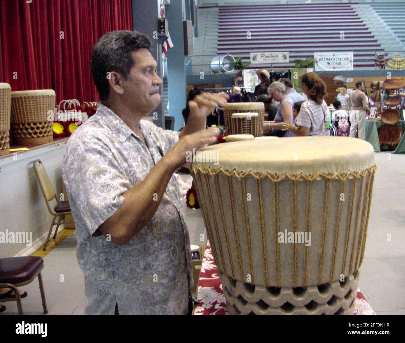 Etua Tahauri beats on a Hawaiian Pahu drum to attract business to his ...