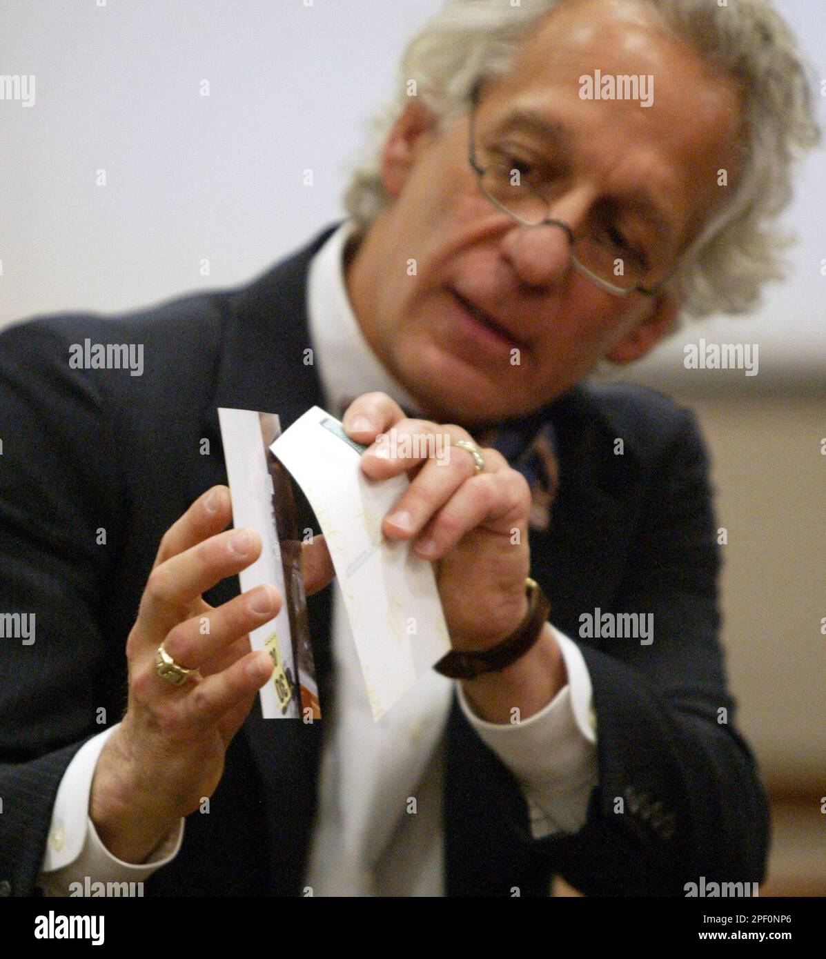Defense attorney David Eisner points out in a photograph the edge of ...