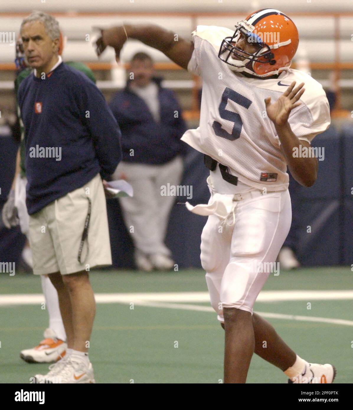 Syracuse freshman quarterback Joe Fields (5) throws under the watchful ...