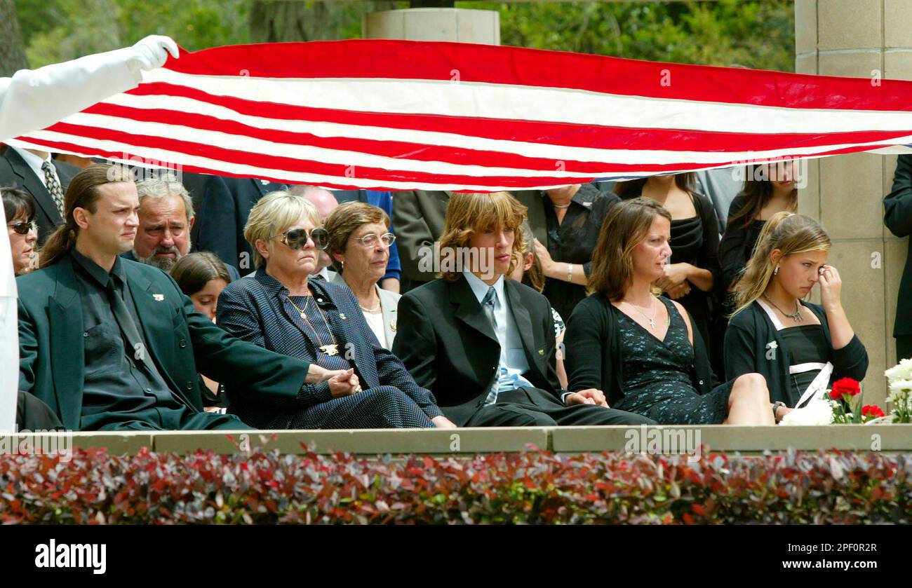 The U.S. flag is folded above the heads of the family of Scott ...