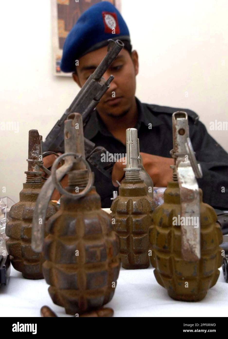 Police officer examines ammunition recovered from militants, Monday ...