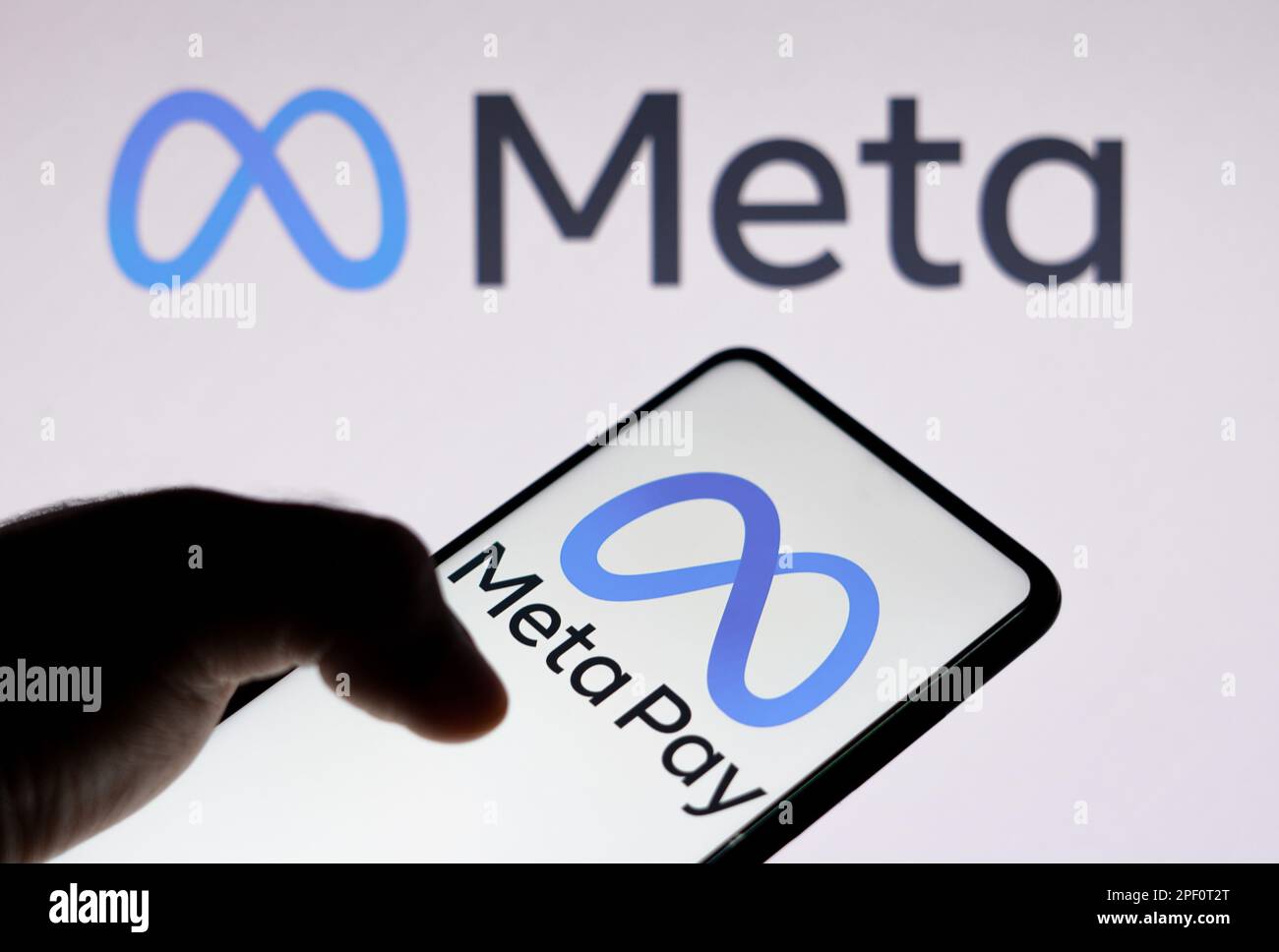 In this photo illustration the Meta Pay logo seen displayed on a smartphone and in the ...