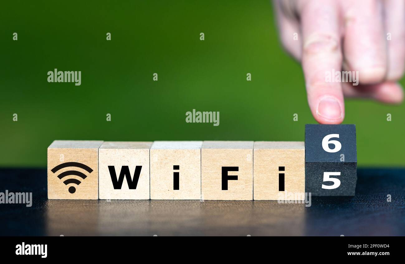 Hand turns cube and changes the expression WiFi5 to WiFi6 Stock Photo ...