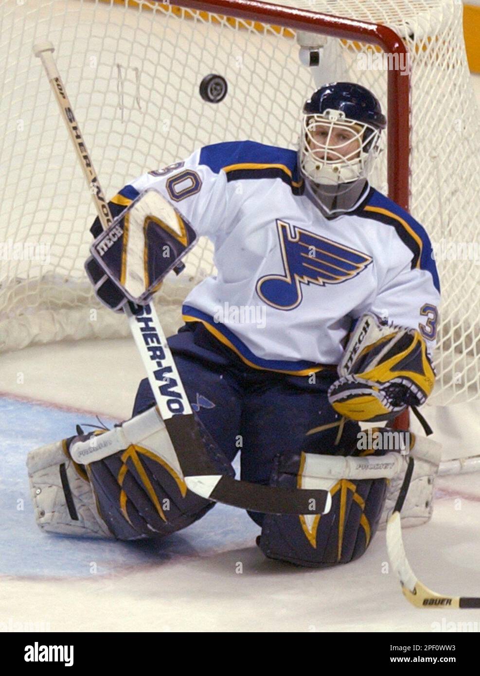 St. Louis Blues goalie Chris Osgood blocks a shot by a San Jose Sharks ...
