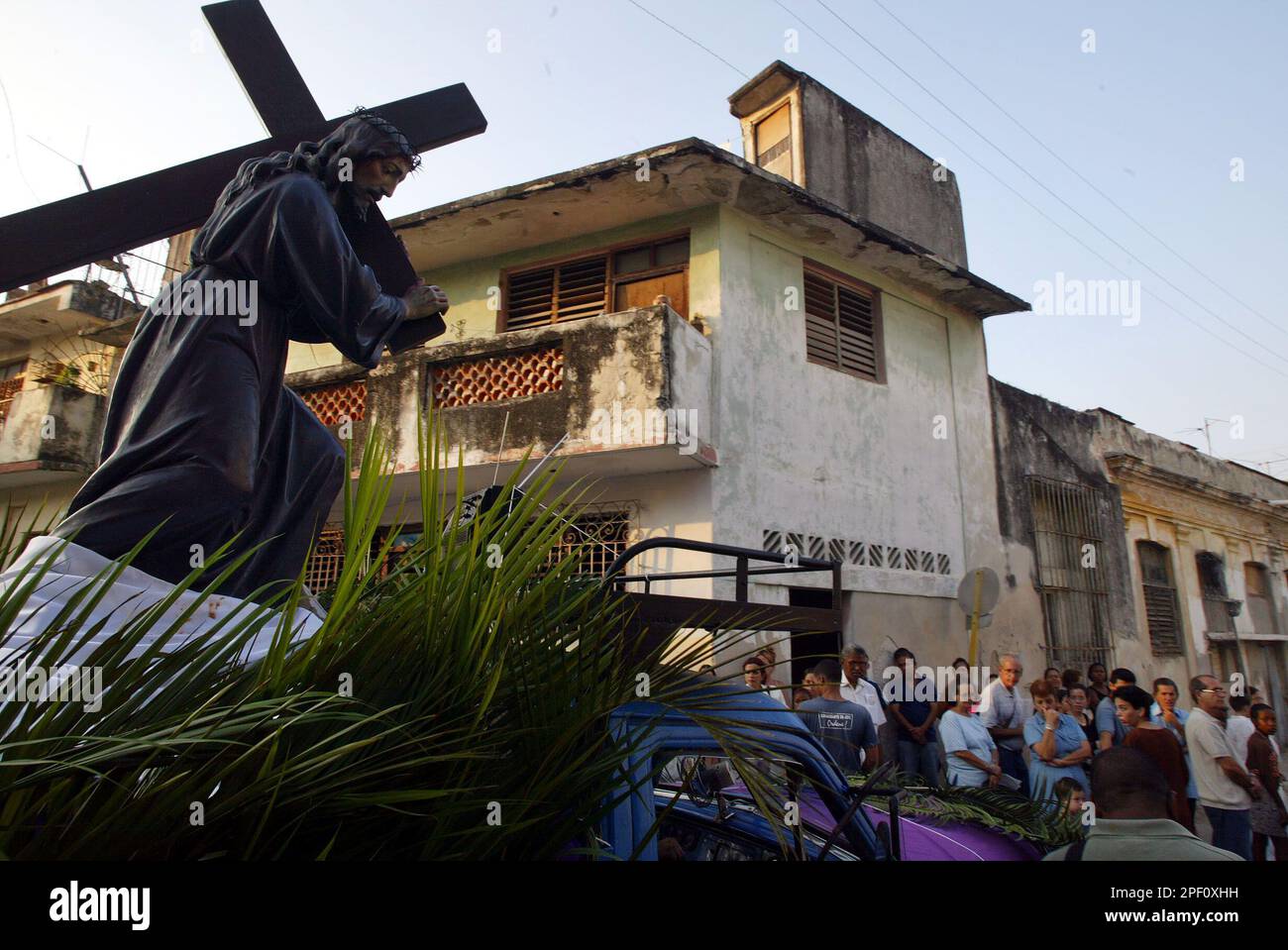 Jesus Christ 's statue is transported on a 1952 Plymouth during a Via ...