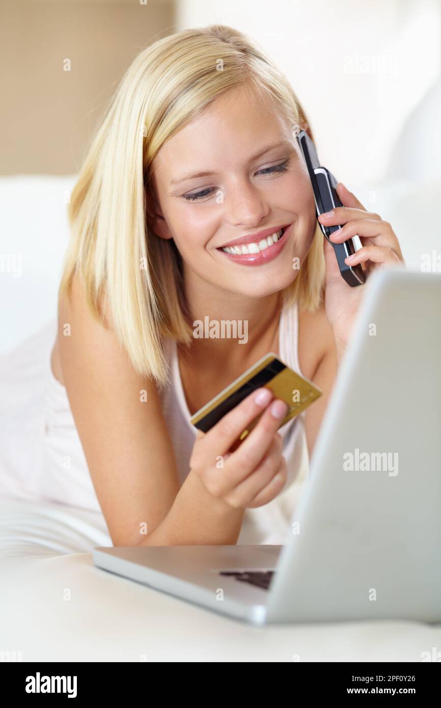 Making reservations for a date. A gorgeous young woman buying something ...