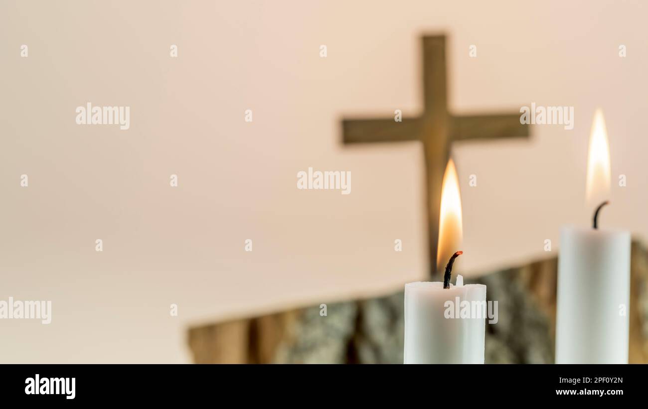 Wooden cross with white candles on gradient background with copy space ...