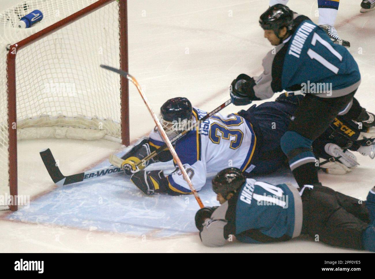 St. Louis Blues goalie Chris Osgood blocks a shot by San Jose Sharks ...