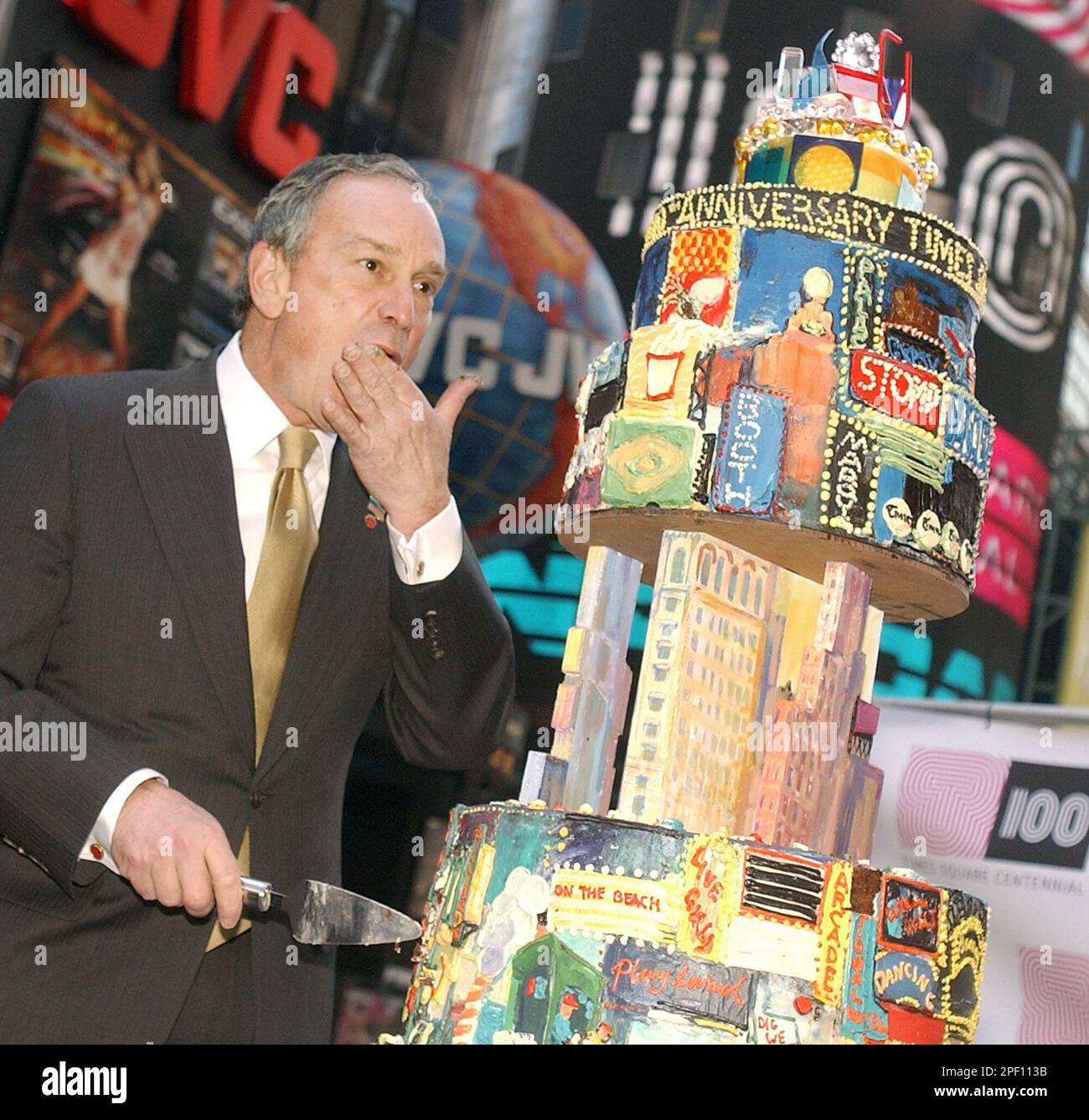 New York Mayor Michael Bloomberg licks the frosting off his fingers ...