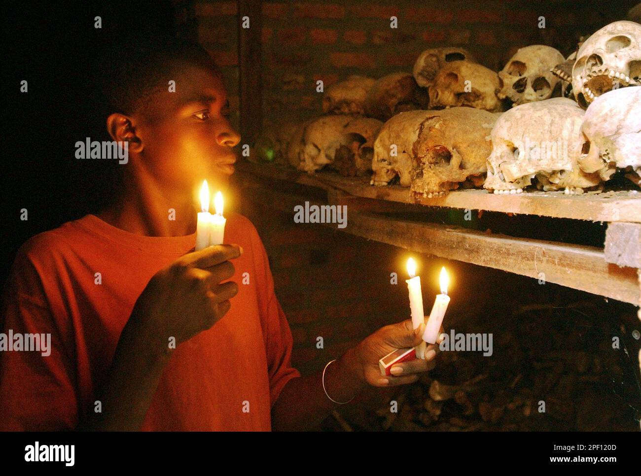 Apollan Odetta, a survivor from the 1994 Rwandan Genocide light candles ...