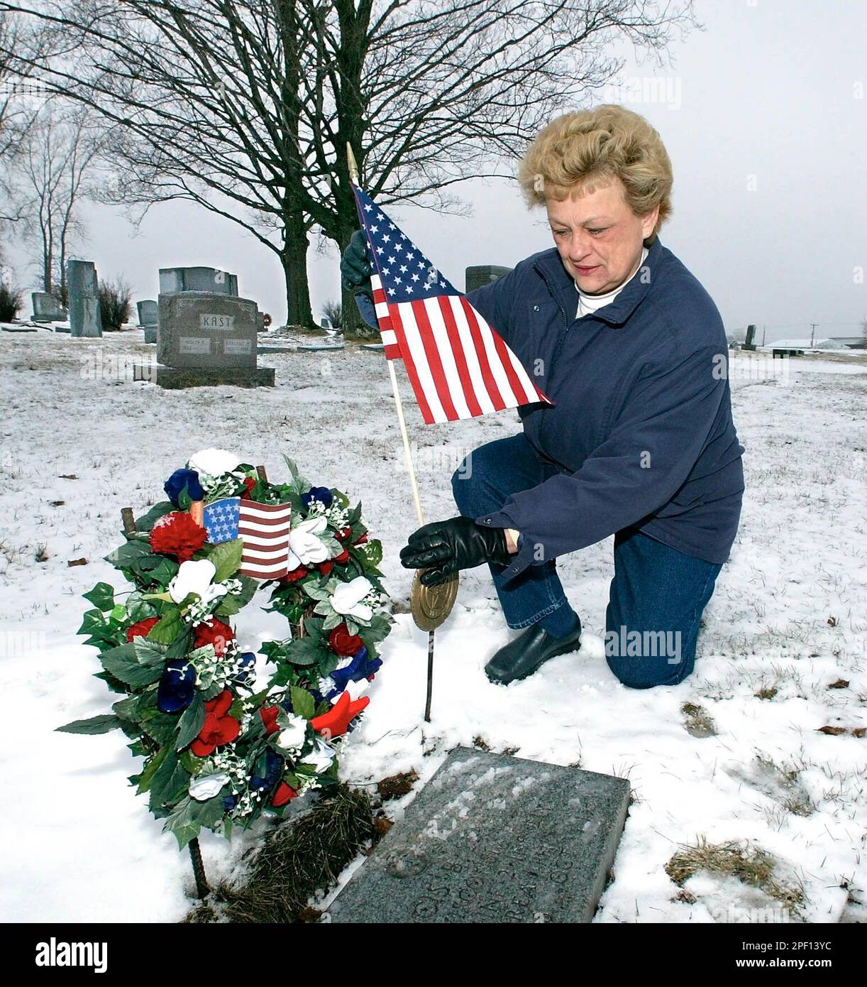 Angela Spade puts a flag on the grave of her brother, Francis Spaeth ...