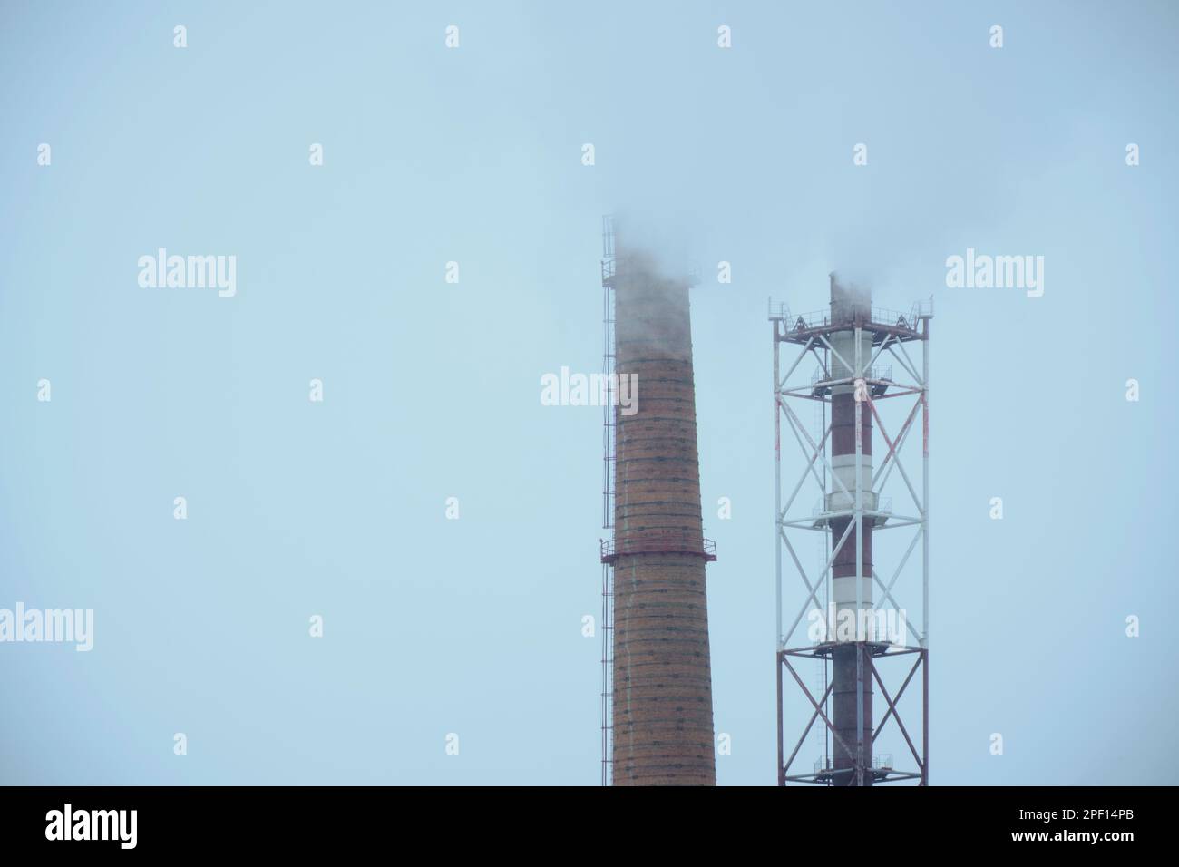 Two industrial pipes smoke polluting the environment with harmful gases ...