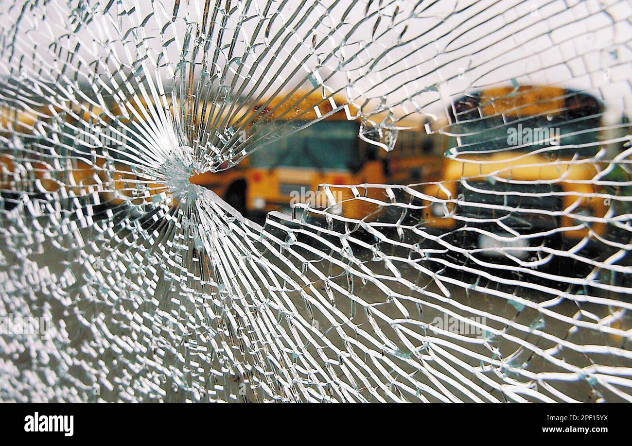 A broken window of a school bus, that police say, was shot by BB guns ...