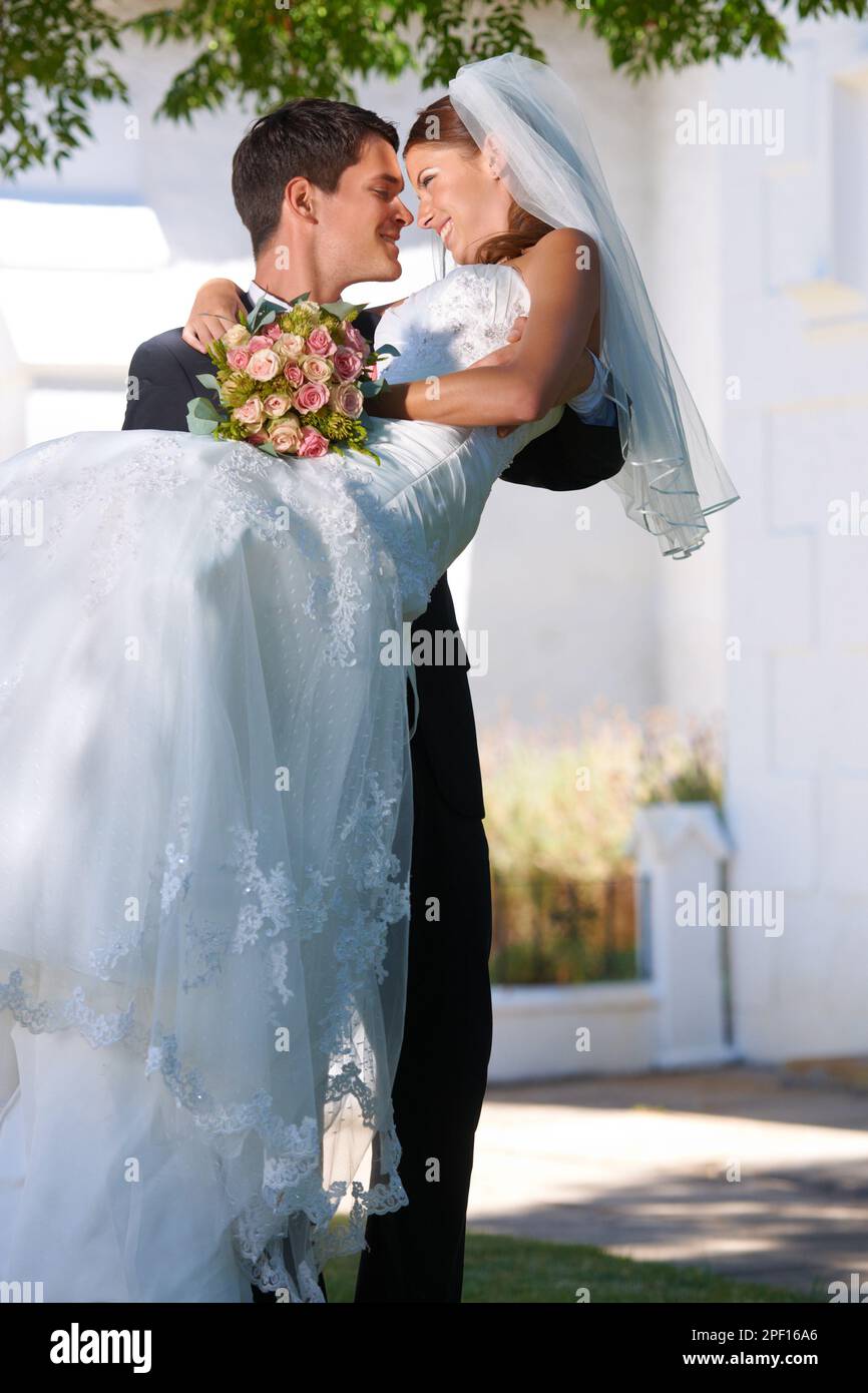 Theyre a support to each other. a groom playfully carrying his new ...