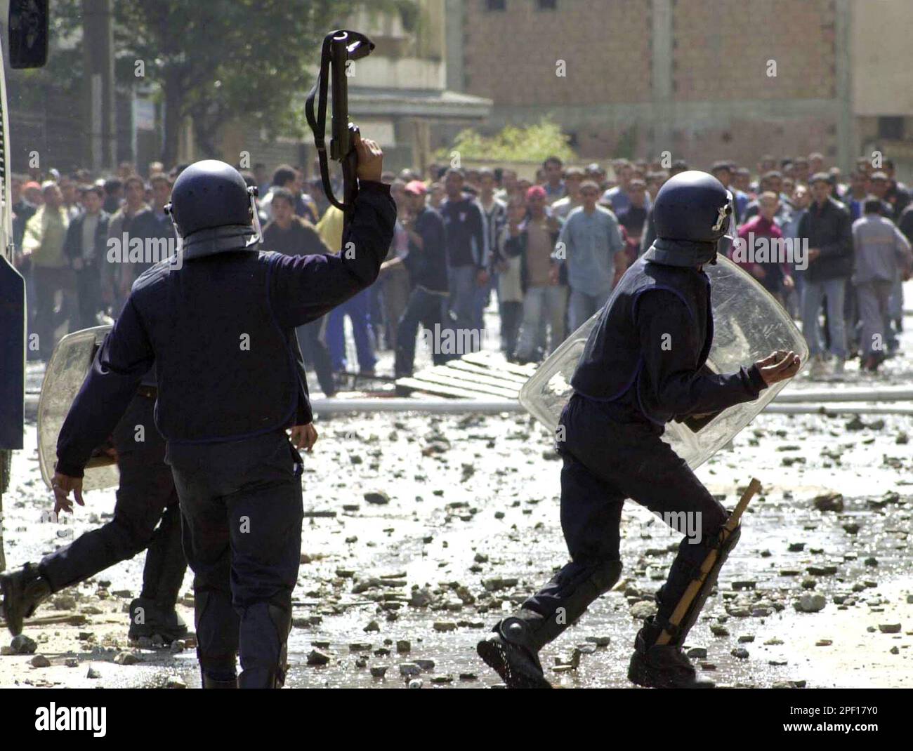 Riot police face protesters demonstrating at the Algerian president's ...