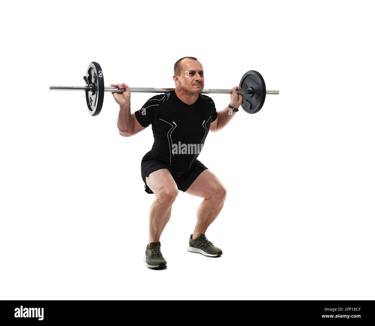 Athletic middle age man doing squats fitness workout with barbell ...