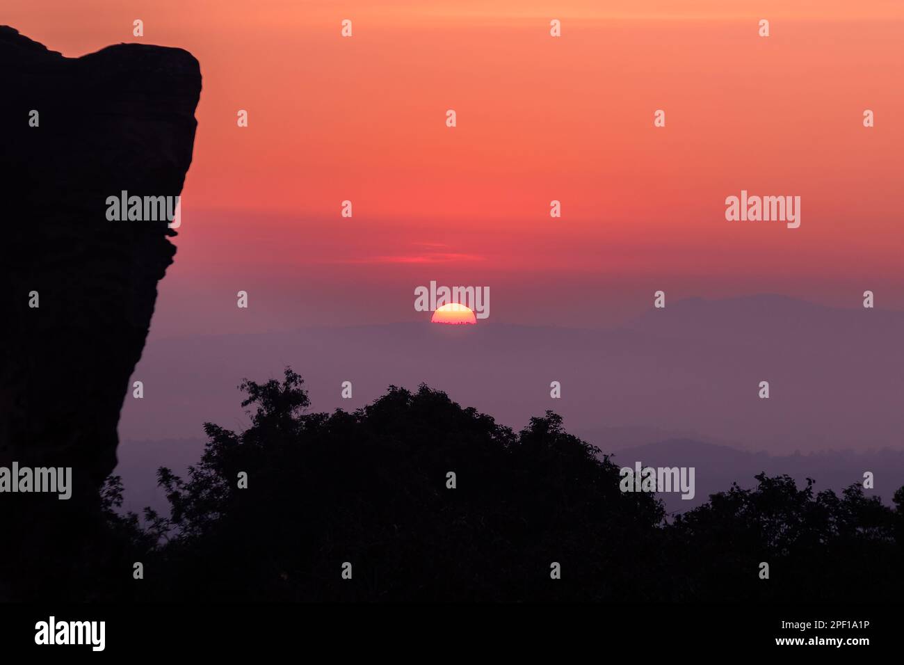 The landscape of the rising sun shines orange glow across the sky Stock ...