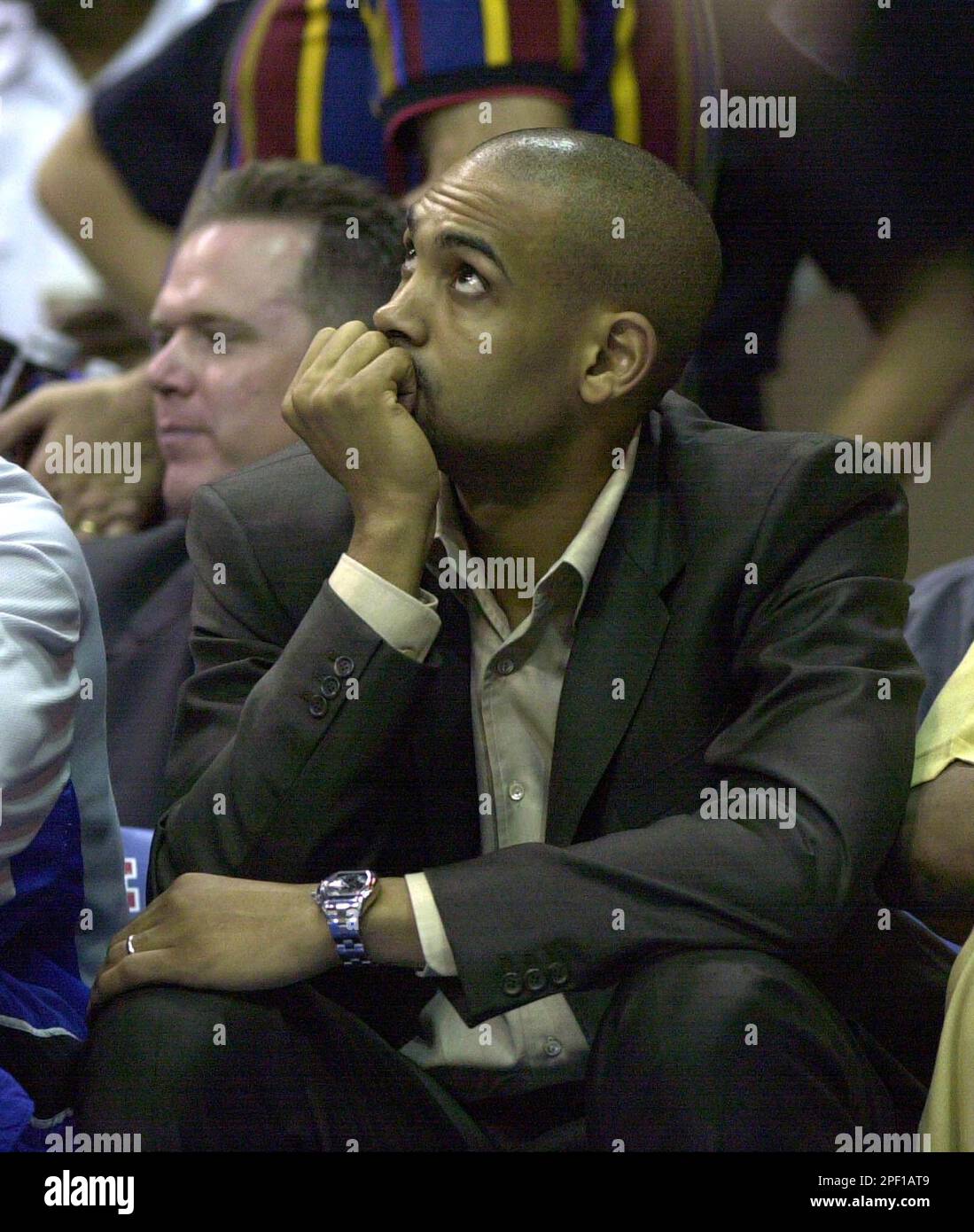 Injured Orlando Magic forward Grant Hill looks up at the scoreboard ...