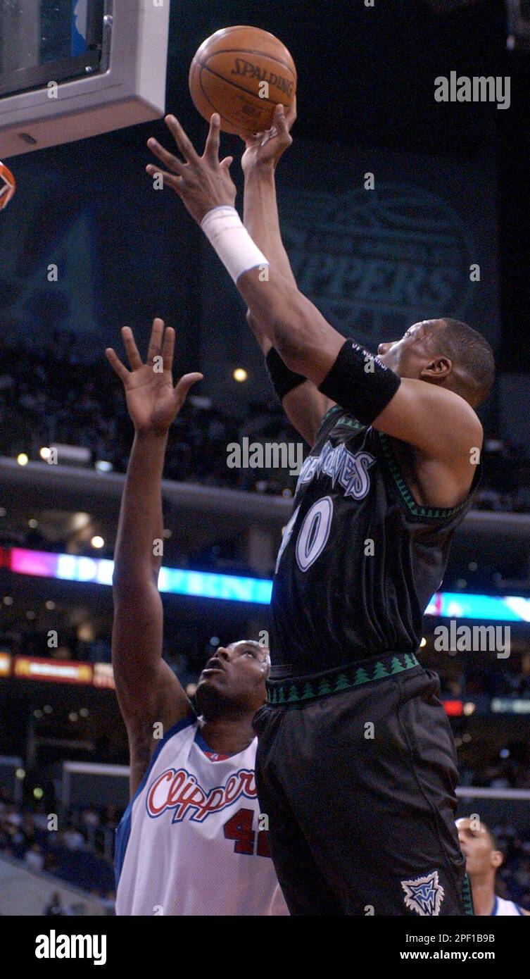 Minnesota Timberwolves center Ervin Johnson, right, shoots over the ...