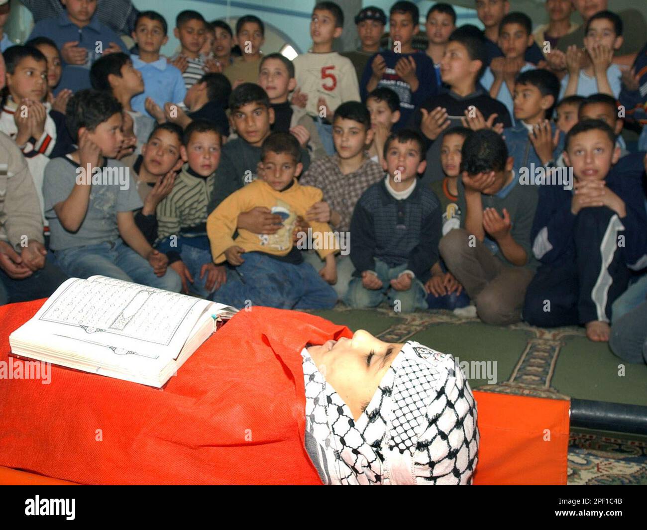 Inside a mosque, children mourn and crowd around the body of 7-year-old ...
