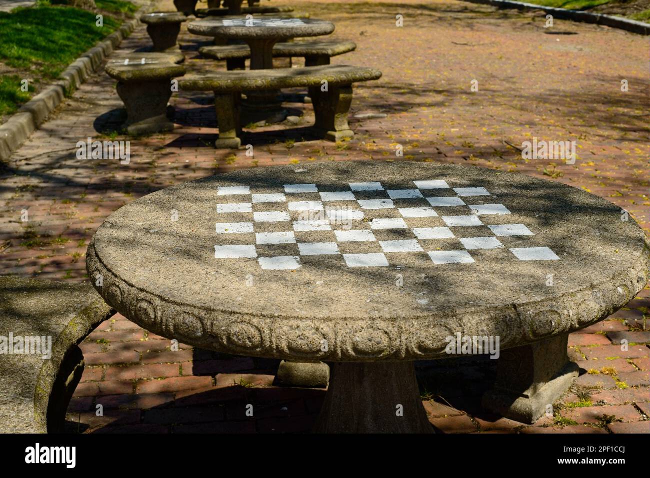 A stone table with a checkerboard painted on its surface stands on a ...