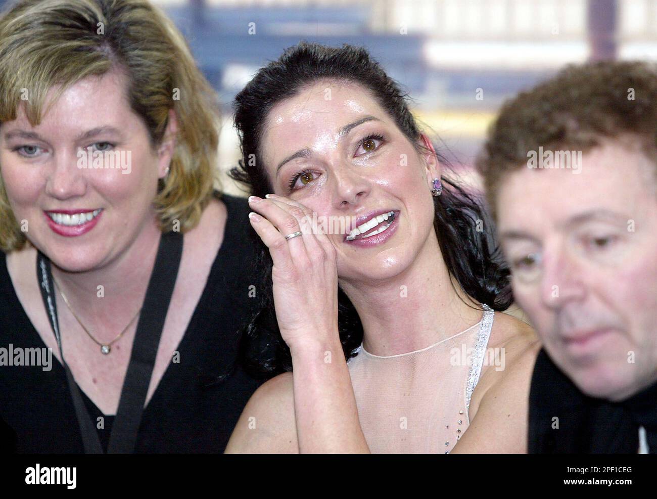 Jennifer Robinson from Canada, center, watches the results together ...