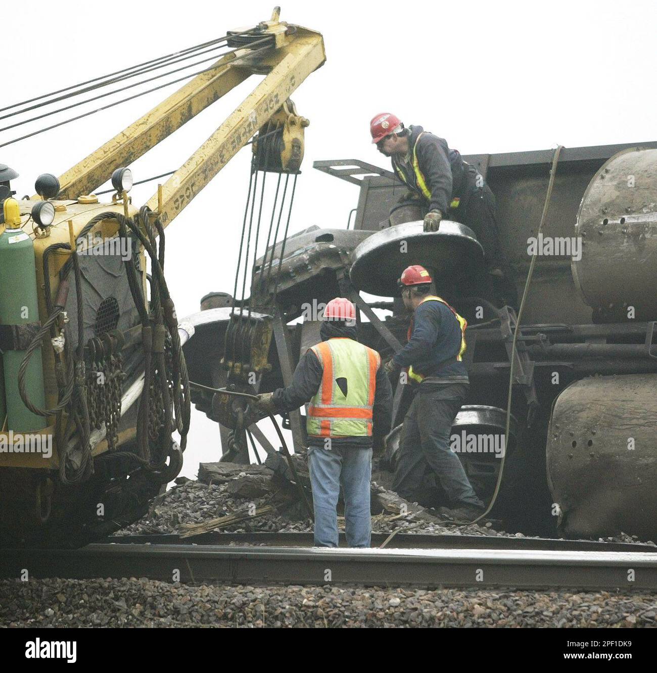 Workers from Hulcher Professional Services, Inc. use a heavy equipment ...