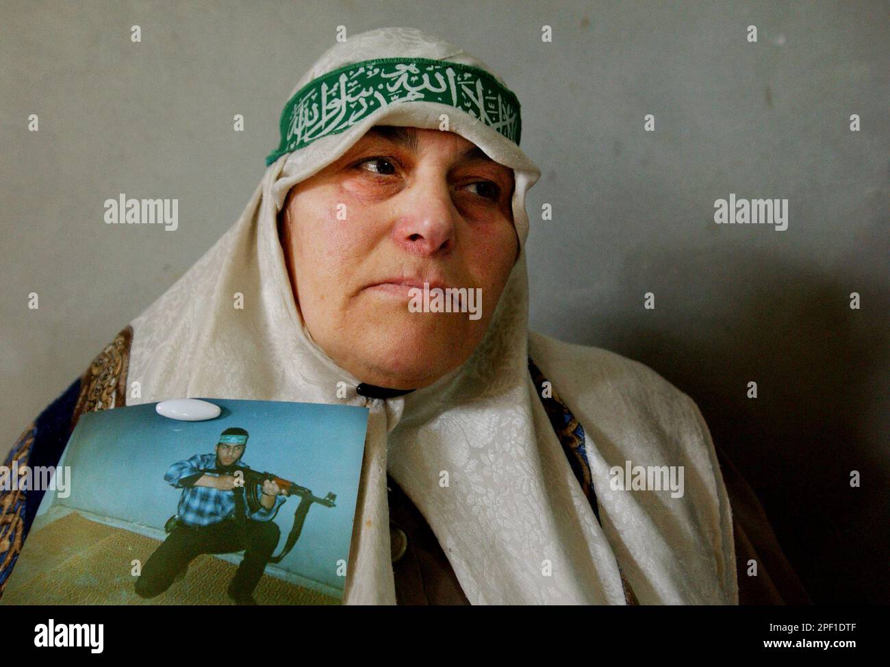 The mother of Hamas militant Izhak Nasser, 18, mourns as she wears a ...