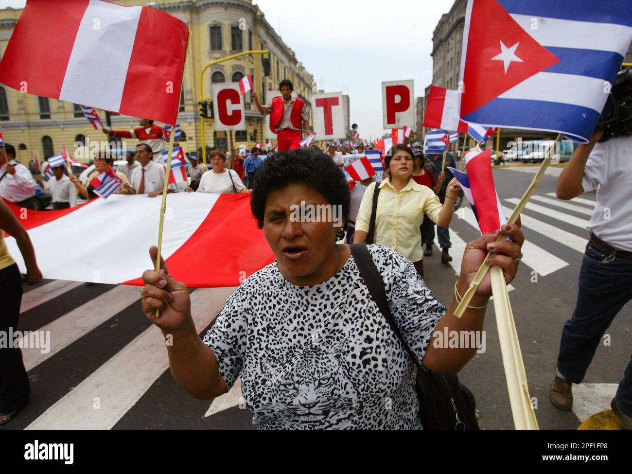 A union worker waves Peruvian and Cuban flags during a demonstration in ...