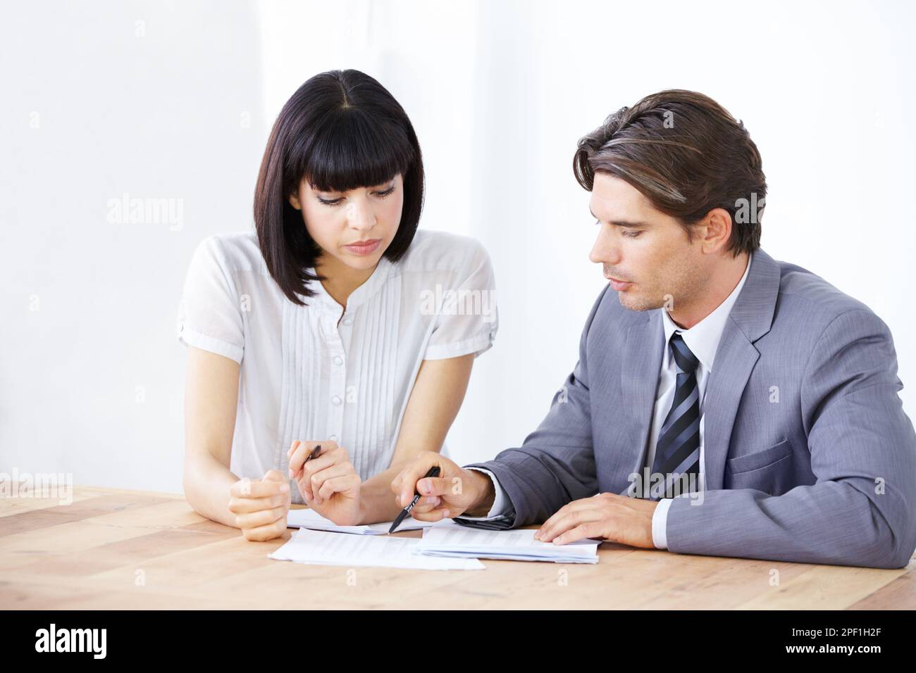 Planning first gets great results. Two young executives going over a ...