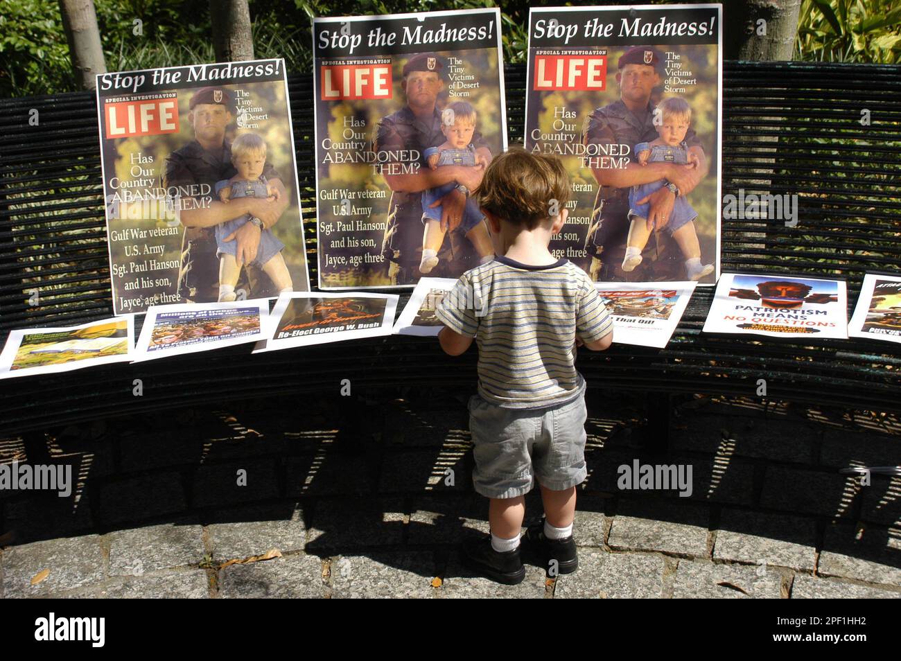 Two-year-old Andrew Gerber looks at anti-war propaganda before war ...