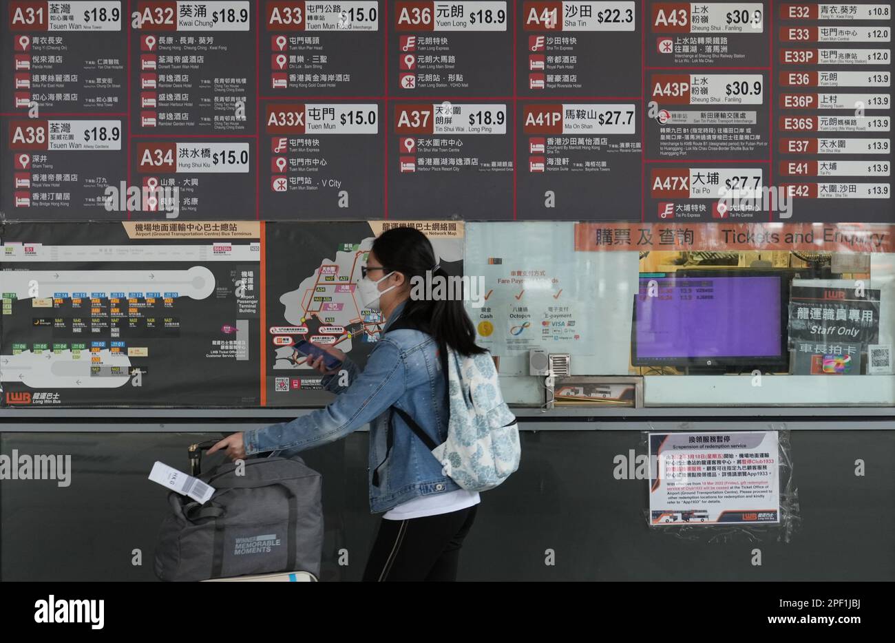 A woman stands in front the ticket counter of Long Win Bus at the bus ...