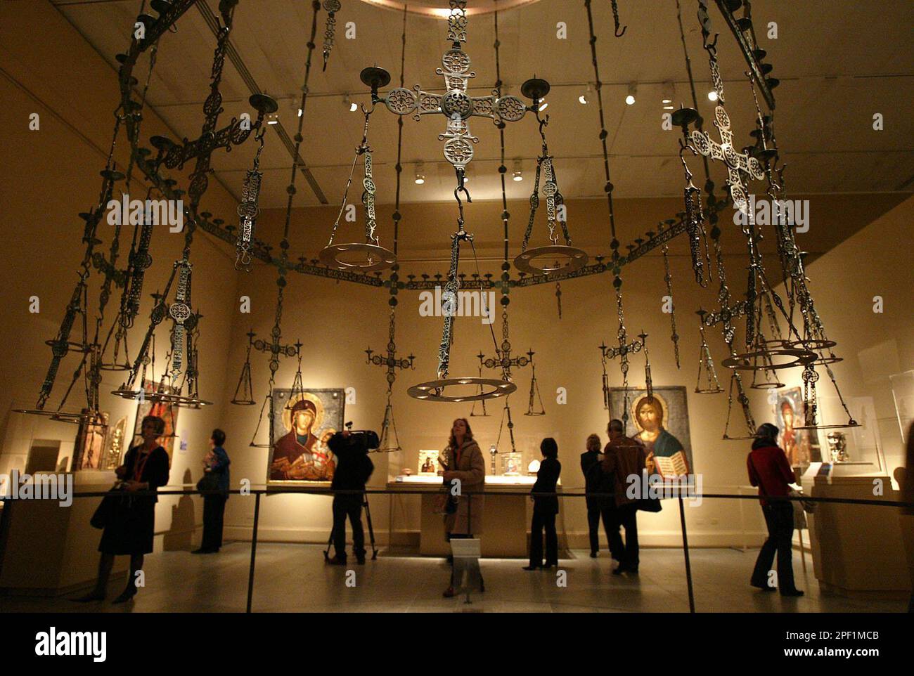 A Byzantine lamp hangs in the center of the room surrounded by other ...