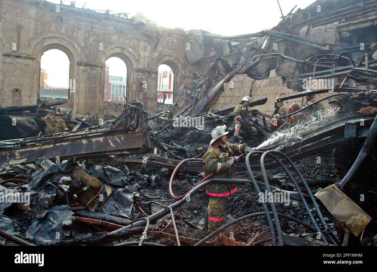 Firefighters work inside of what is left of Manezh, an exhibition hall ...