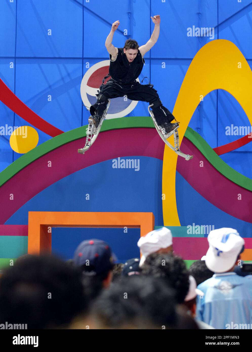 A dancer on spring loaded stilts jumps during a performance at Calle ...
