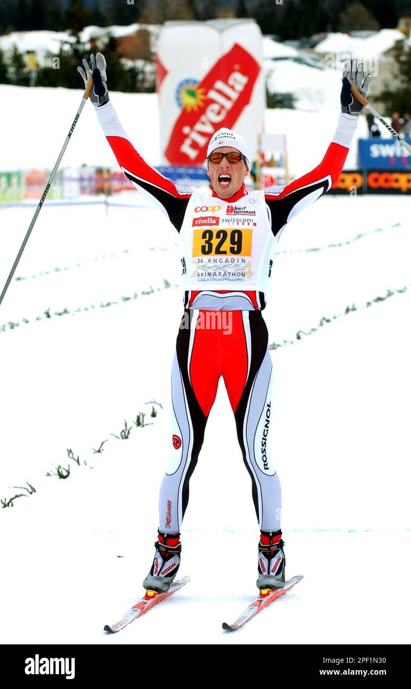 Christophe Perillat of France raises his arms as he crosses the finish ...