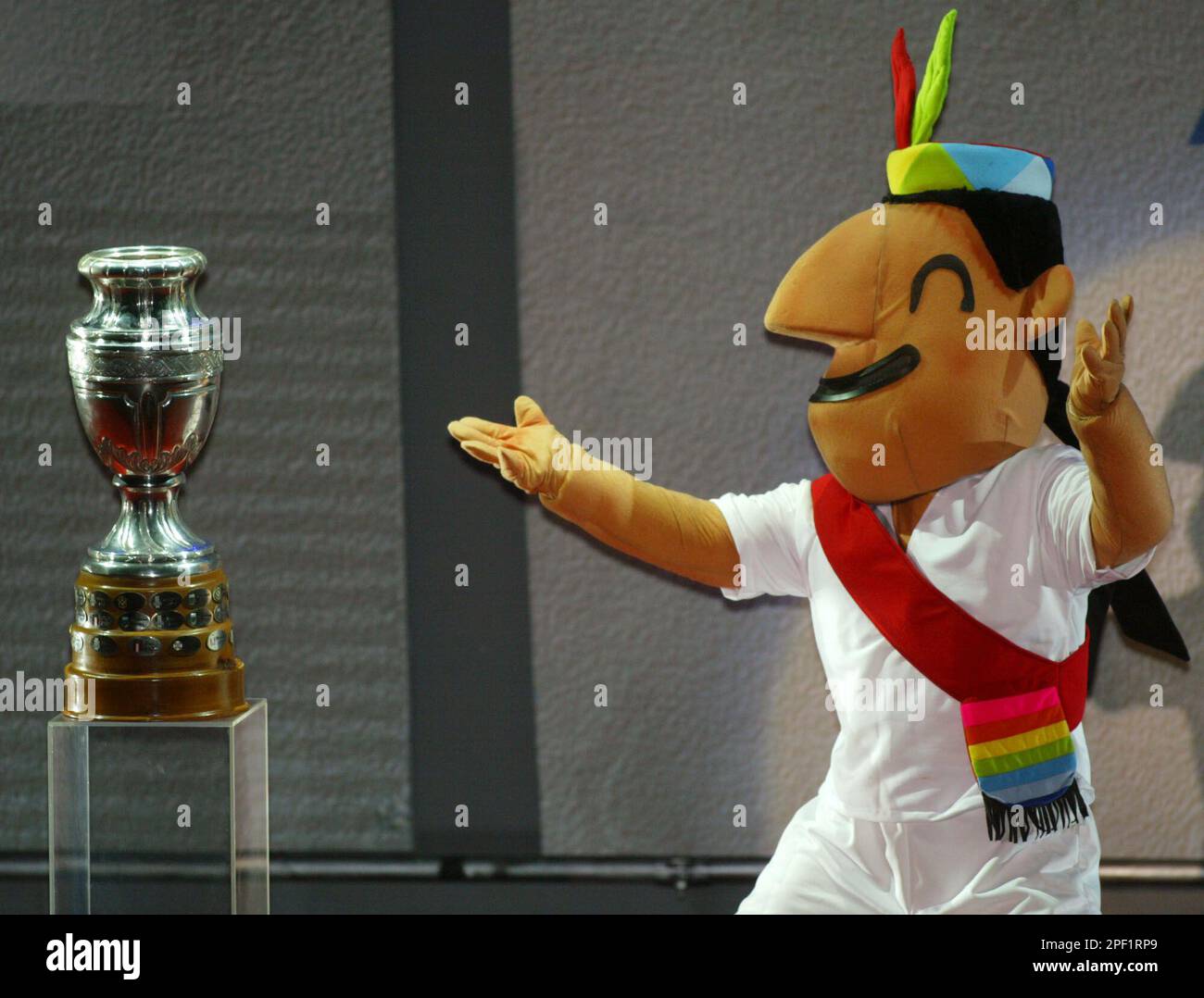 the mascot of the Copa America shows the trophy during the lottery ...
